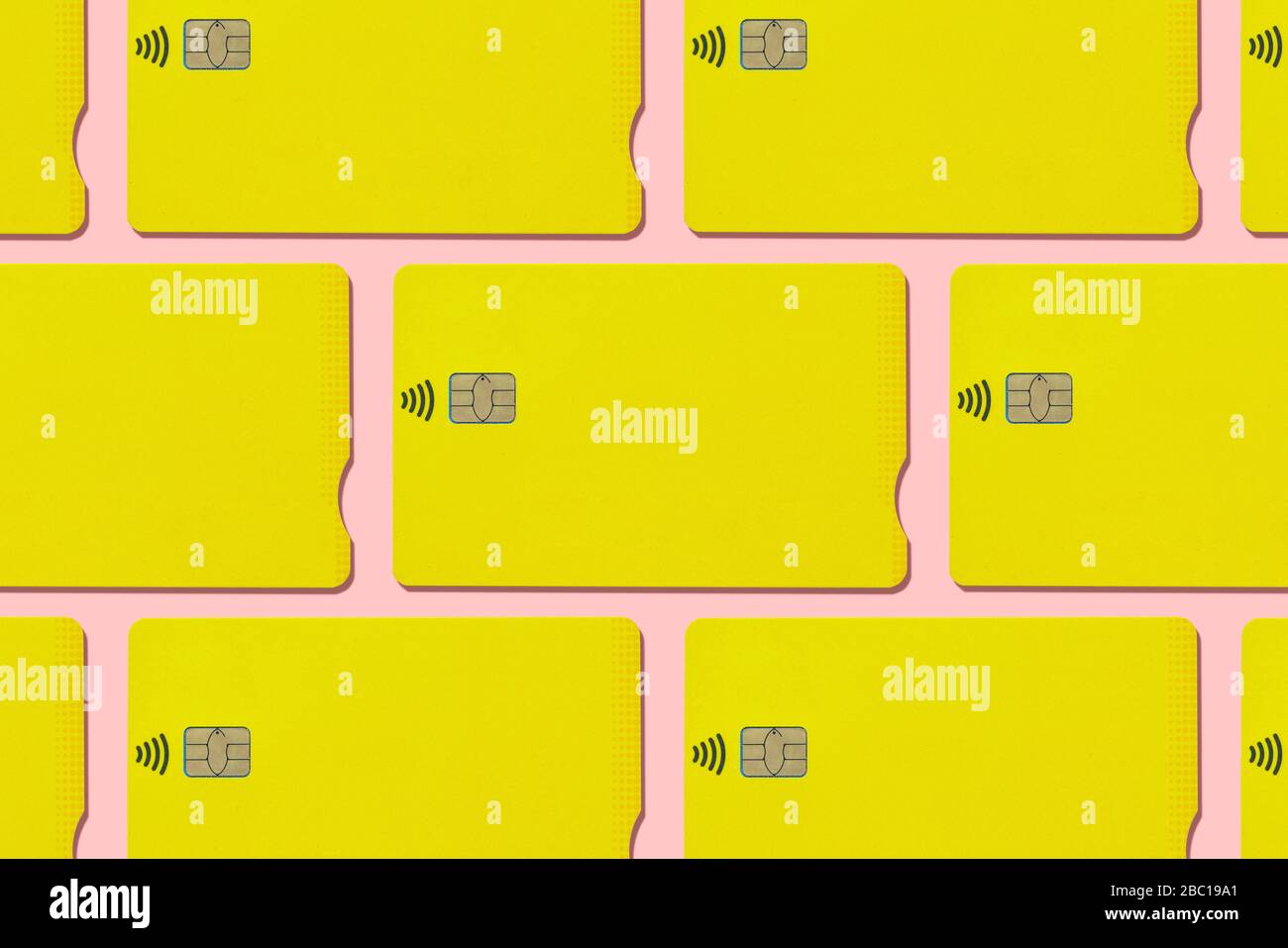 Yellow contactless credit cards pattern on pink background Stock Photo ...