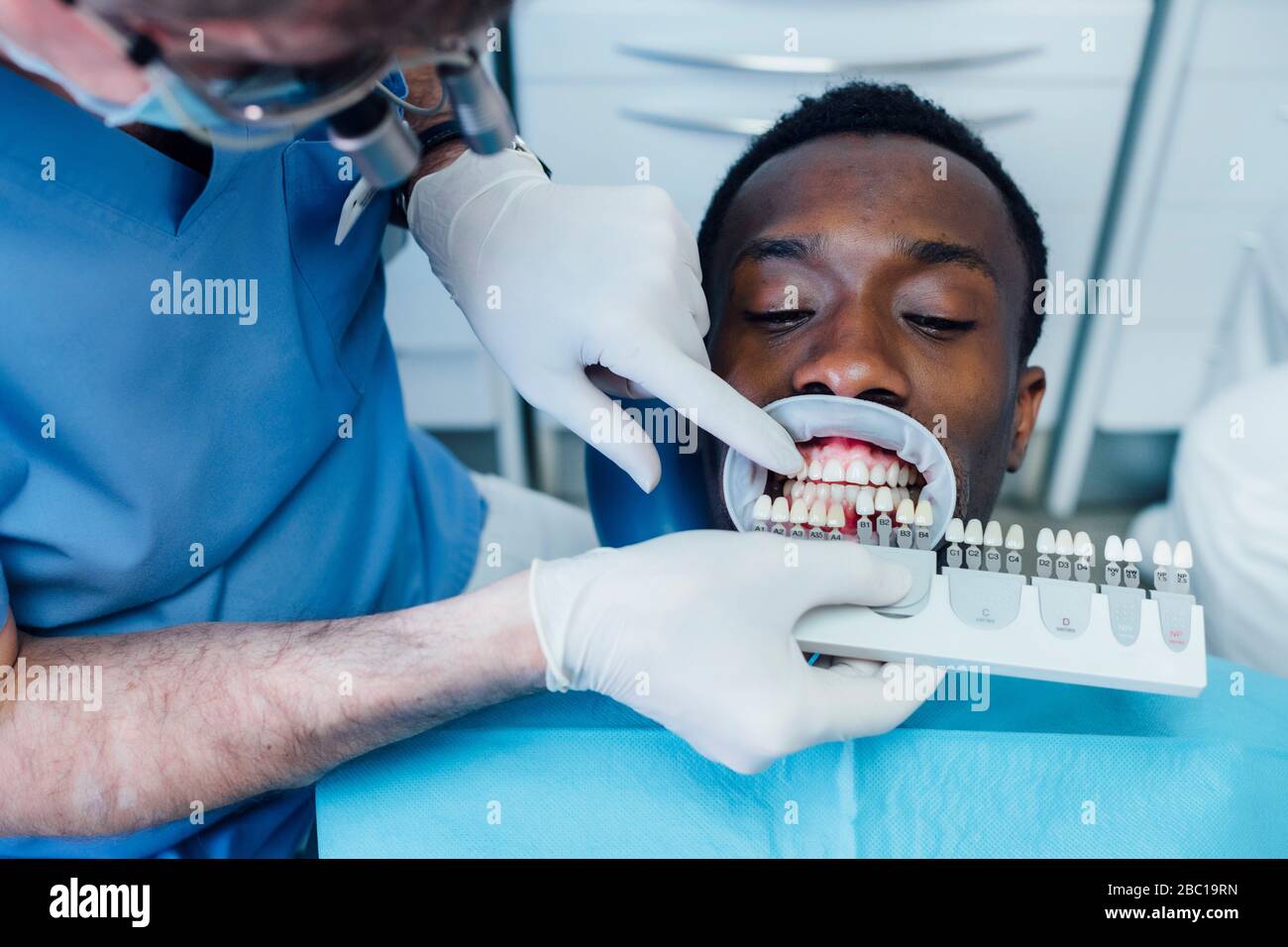 Patient getting dental teeth whitening treatment Stock Photo - Alamy