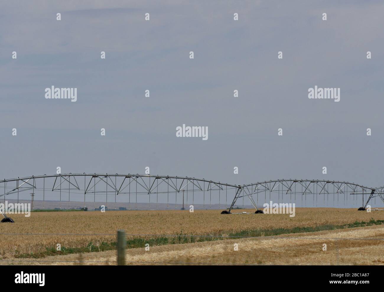 Extended water sprinkler in a farm along the road in Wyoming Stock ...