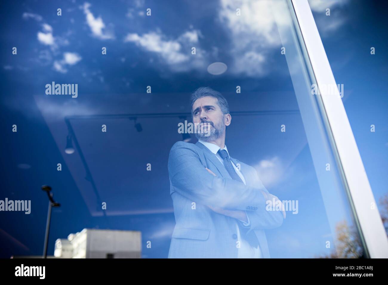 Businessman standing behind glass hi-res stock photography and images ...