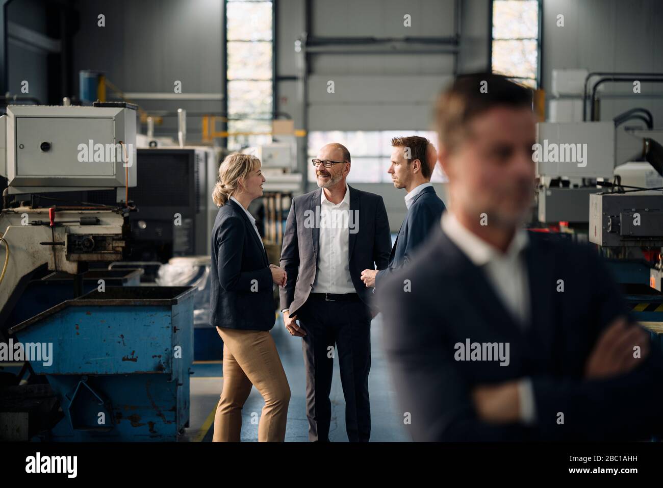 Business team having a meeting in a factory Stock Photo - Alamy