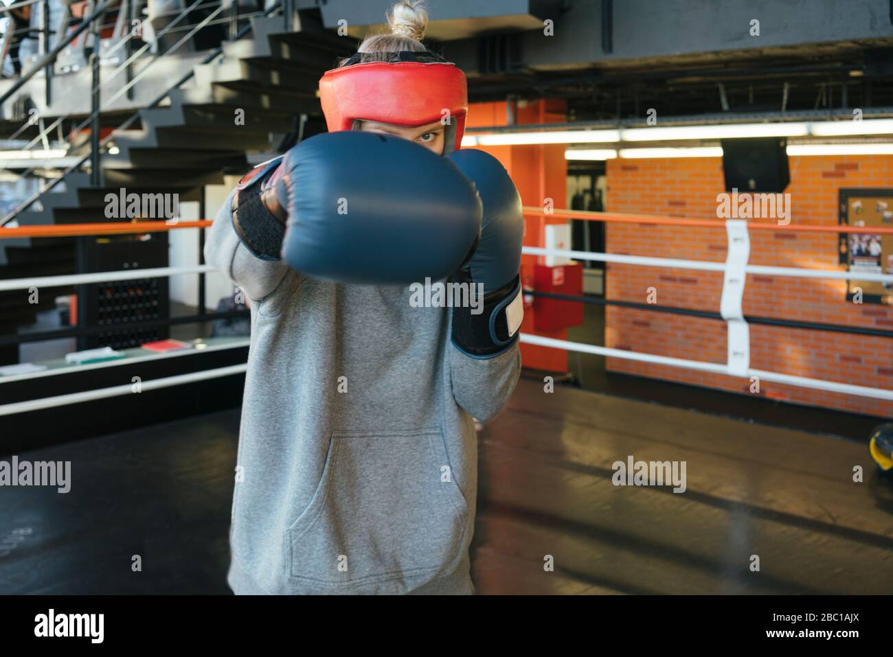 Female boxer punching in ring Stock Photo - Alamy