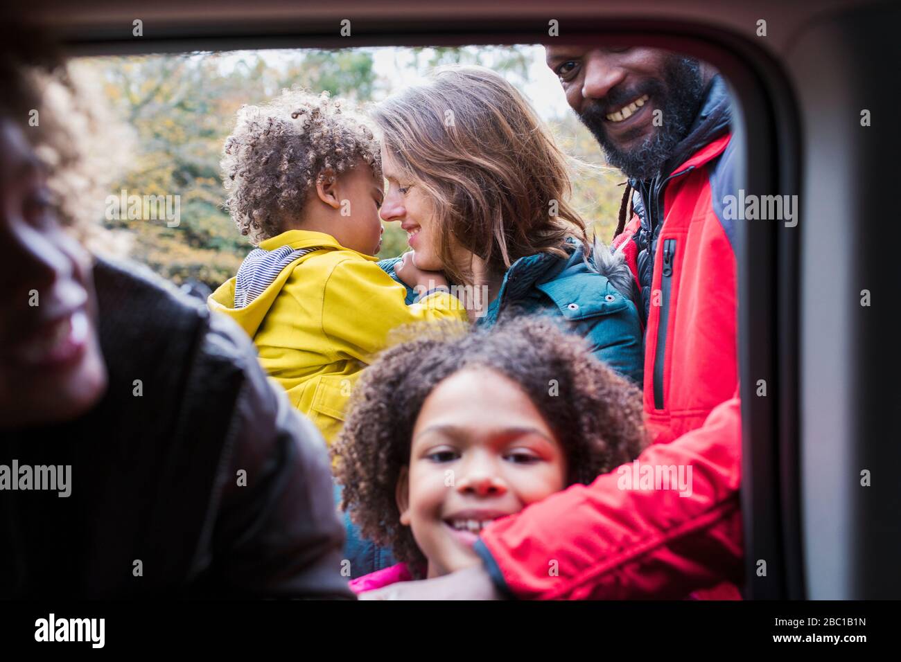 Portrait happy family outside car window Stock Photo - Alamy