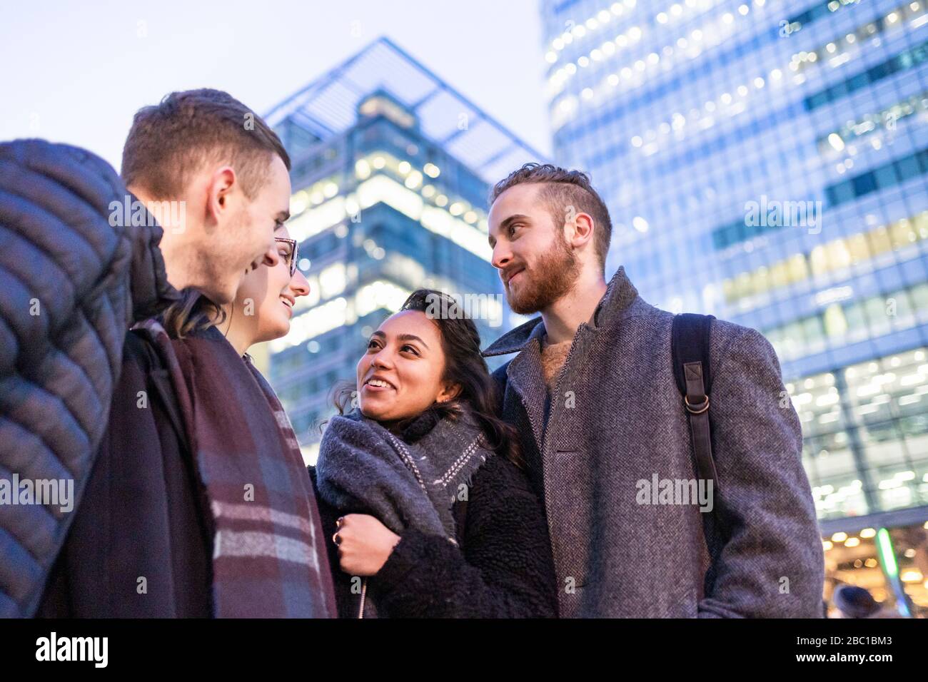 Happy friends talking in the city, London, UK Stock Photo - Alamy