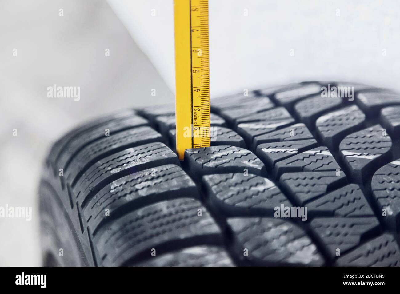 Close-up of winter tire being checked Stock Photo - Alamy