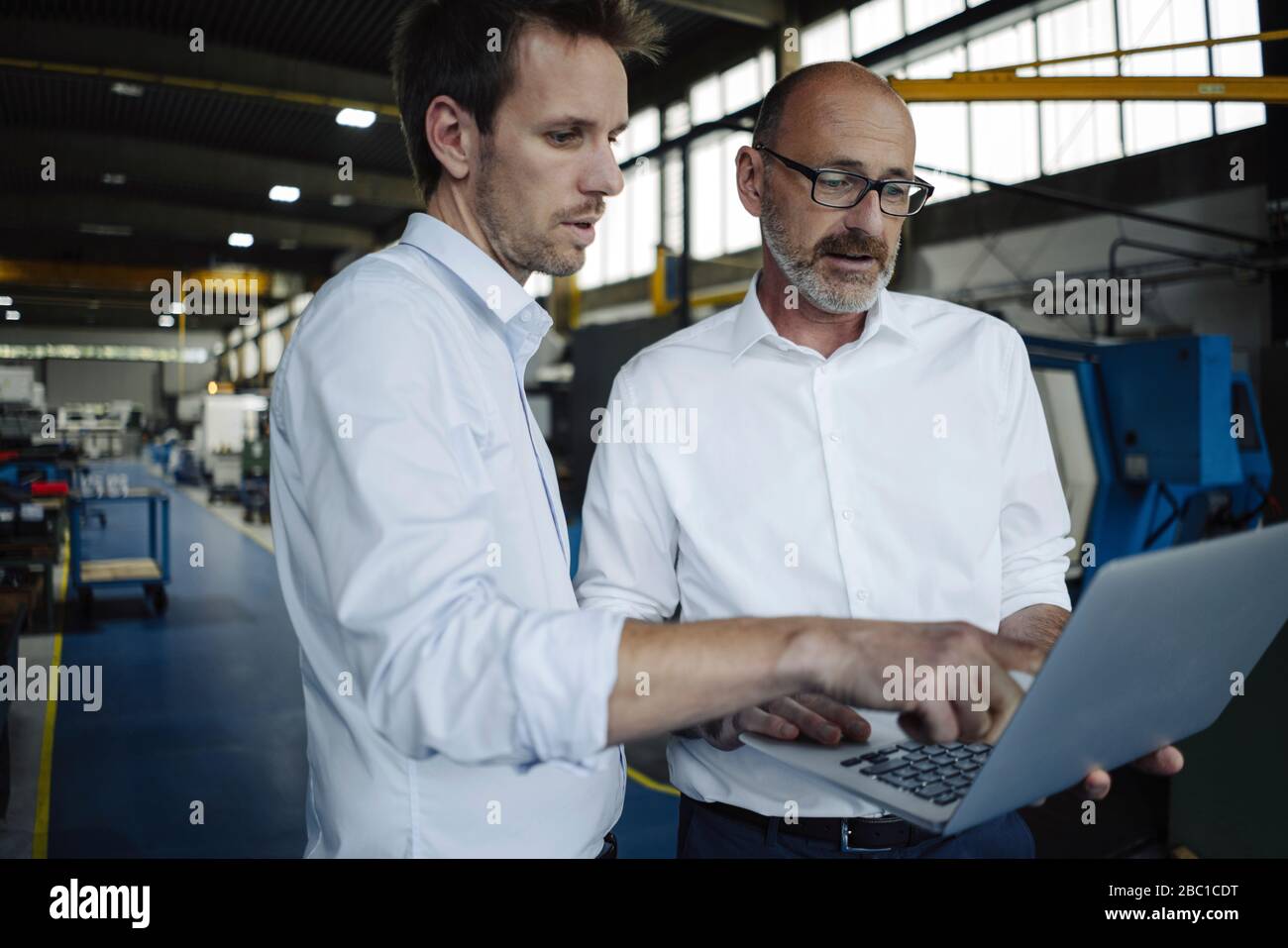 Two men laptop mobile hi-res stock photography and images - Alamy