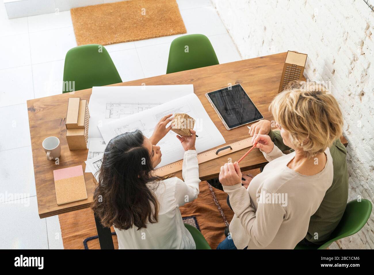 Top view of two women discussing in architectural office Stock Photo ...