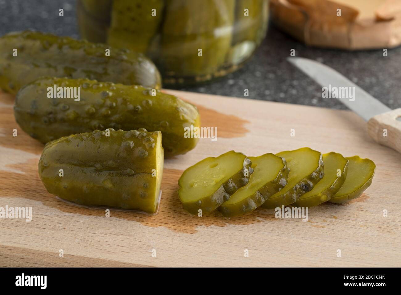 Whole and sliced pickles on a cutting board Stock Photo - Alamy