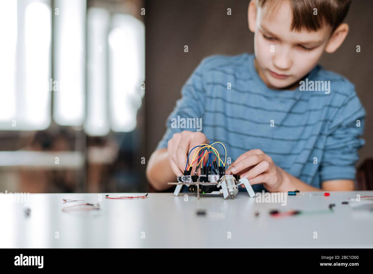 Boy assembling robot at home Stock Photo - Alamy