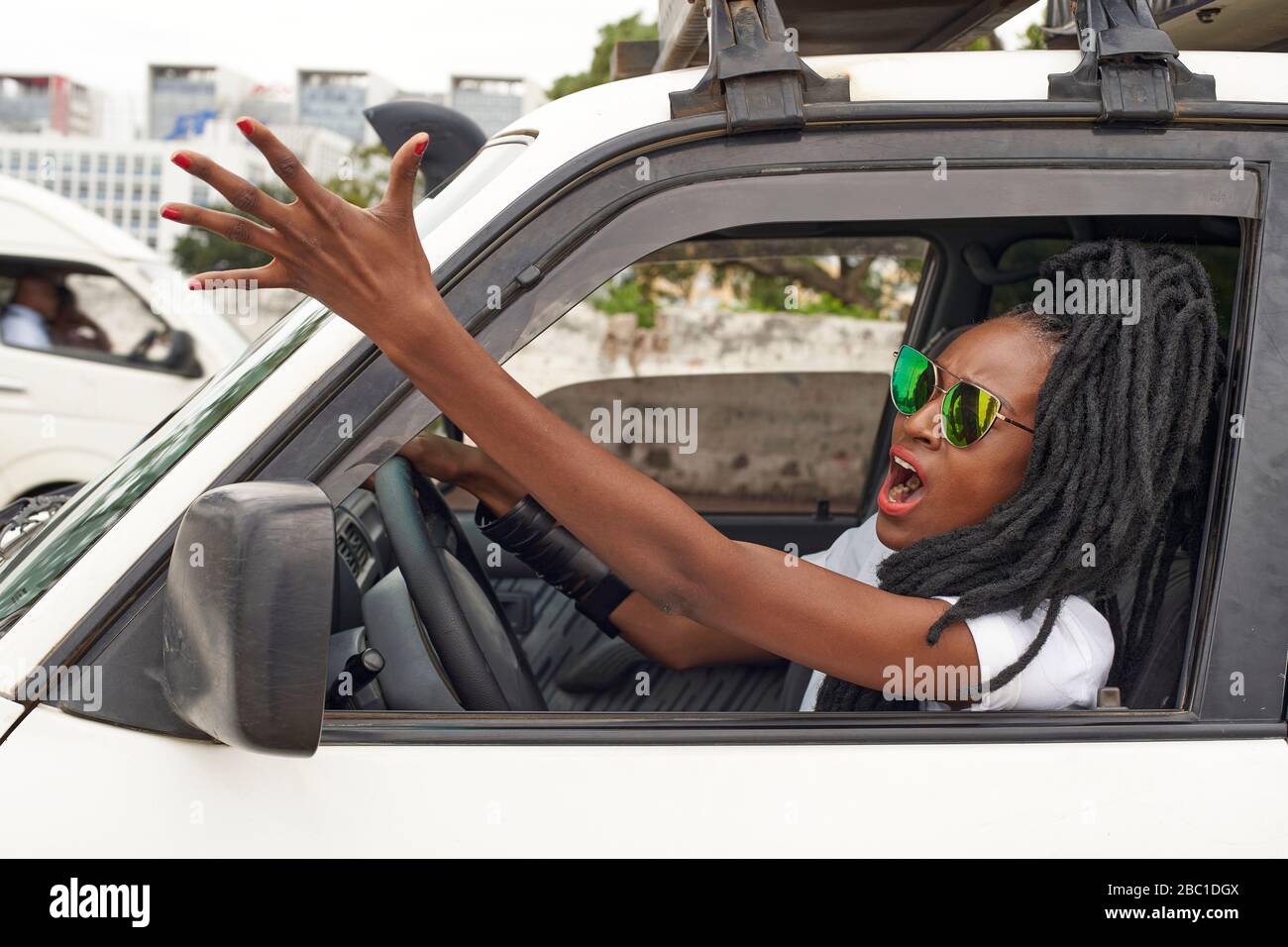 Portrait of angry woman with dreadlocks driving car Stock Photo - Alamy
