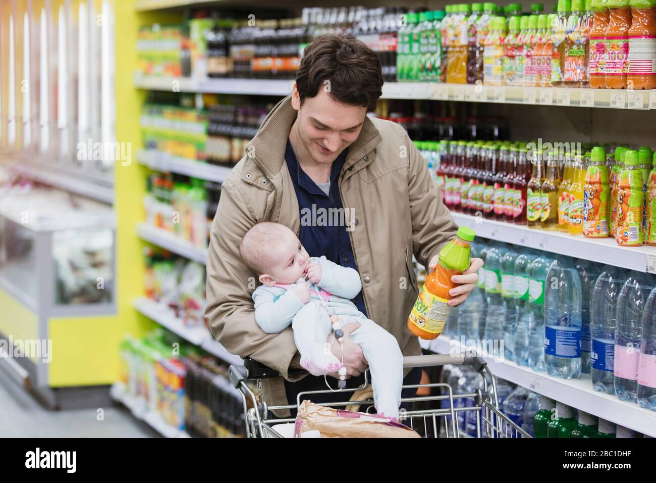 Father with baby daughter shopping in supermarket Stock Photo - Alamy