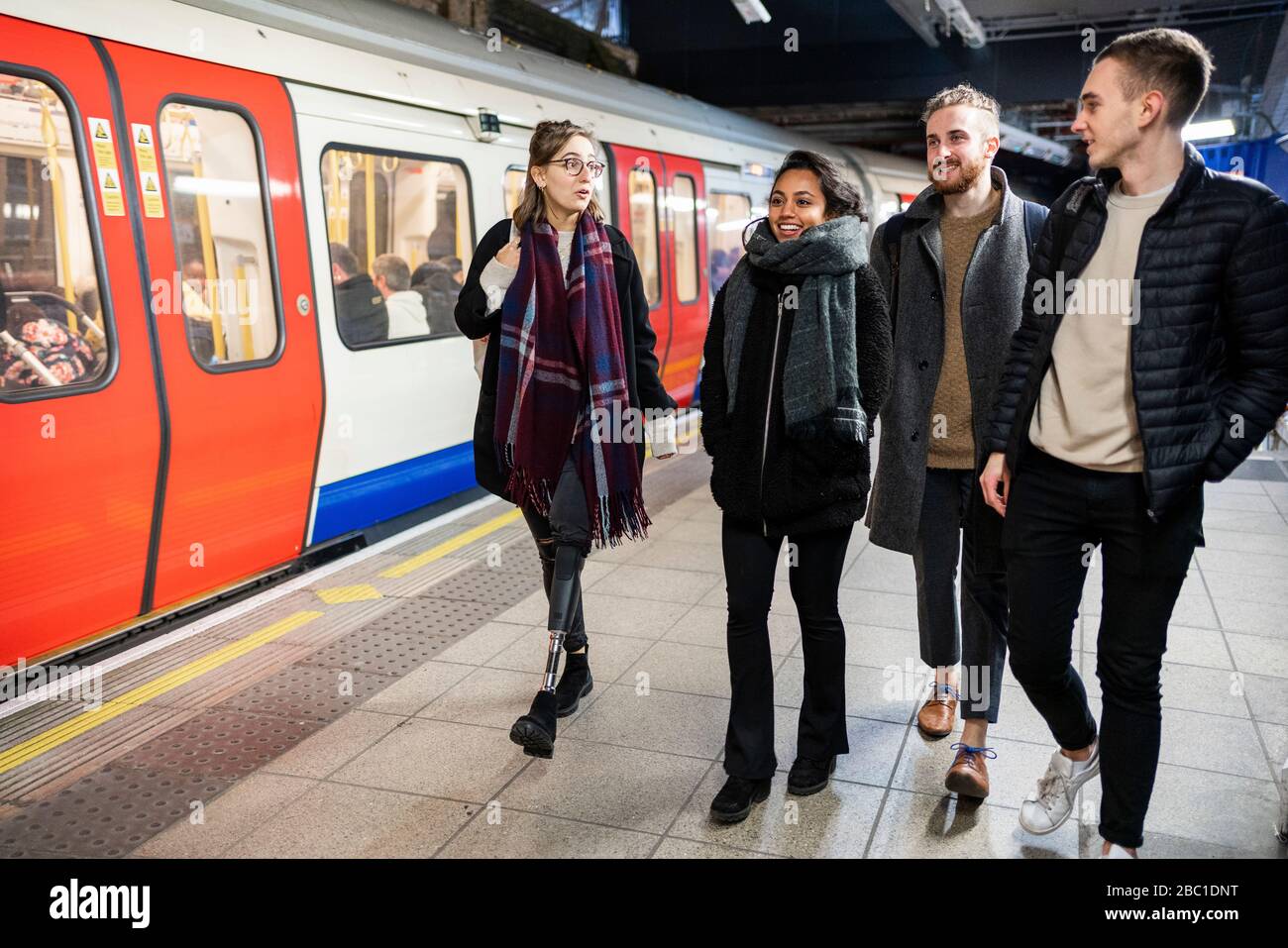 Friends walking at subway station platfom Stock Photo - Alamy