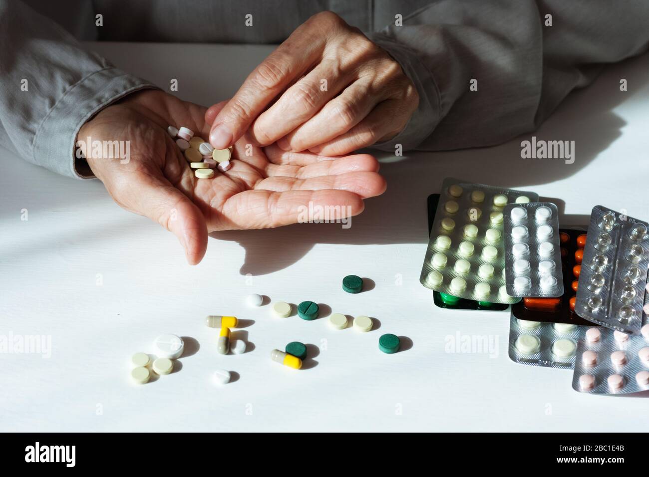 old woman hands close up take a pill from a blister of medicine ...