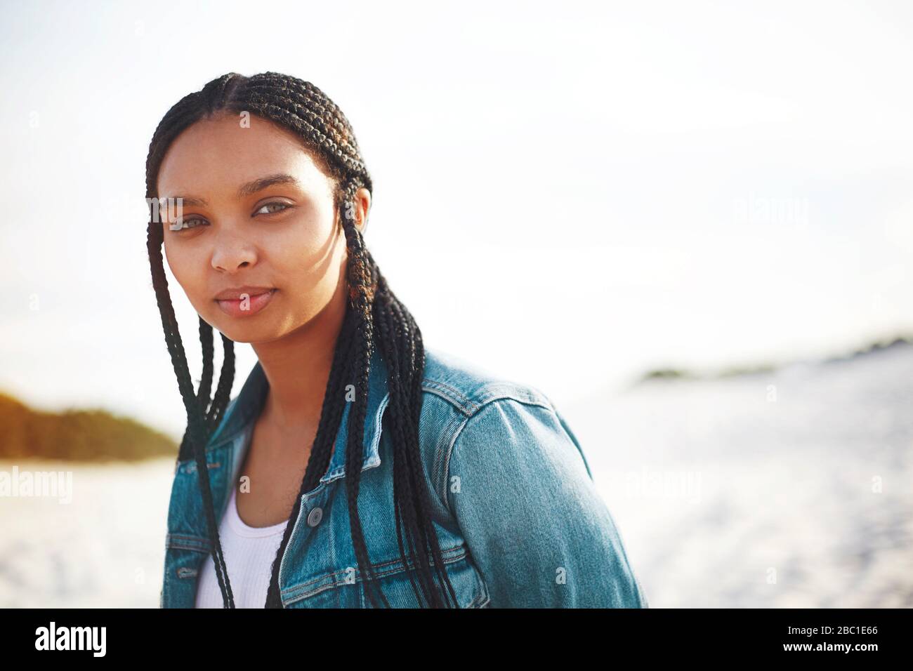 Portrait confident young woman on beach Stock Photo - Alamy