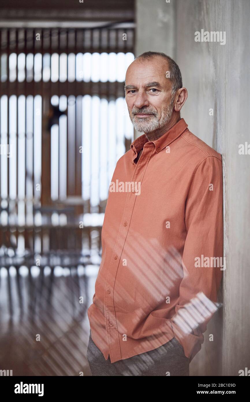 Businessman leaning against office wall hi-res stock photography and ...