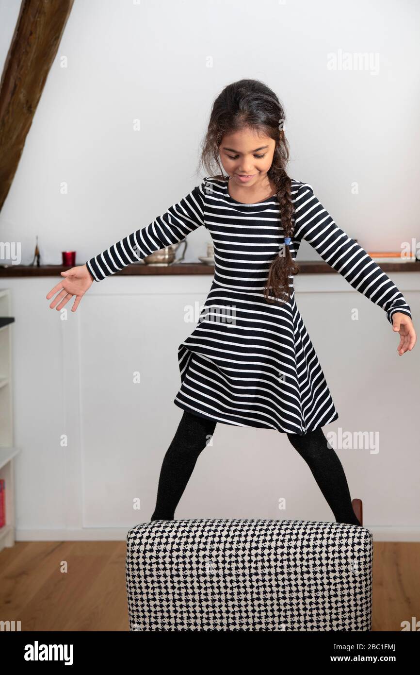 Balancing on armchair hi-res stock photography and images - Alamy