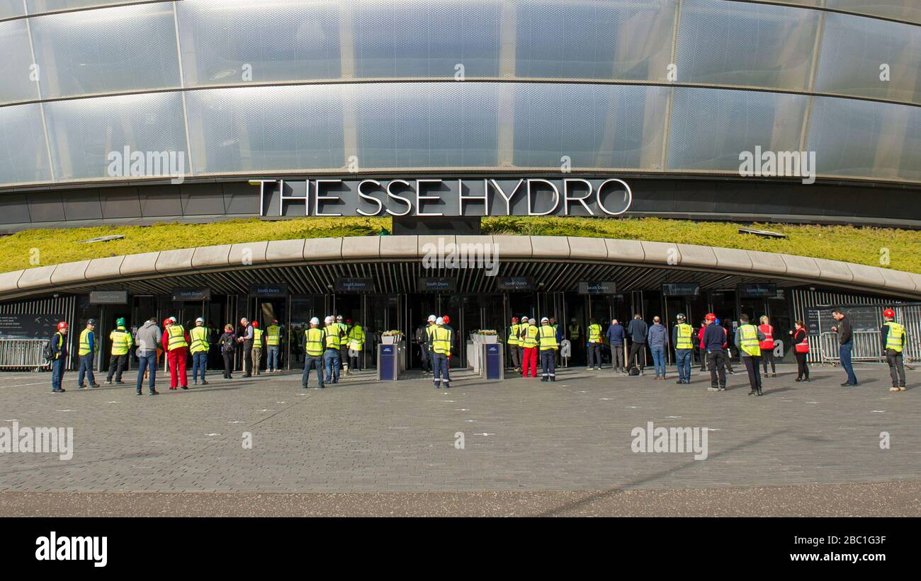 Construction workers standing outside of sse hydro front entrance hi ...