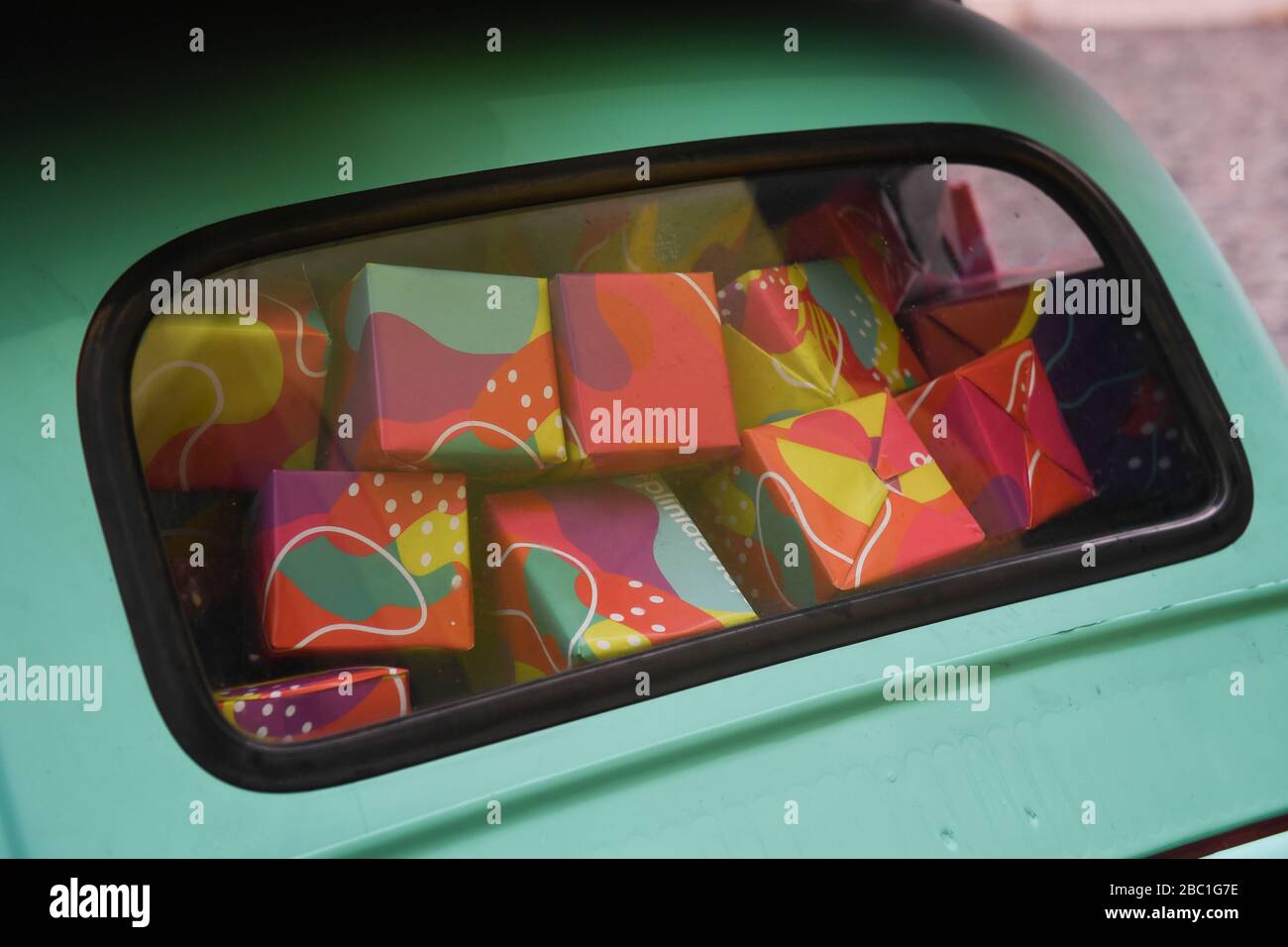 Small retro car full of gift boxes Stock Photo - Alamy