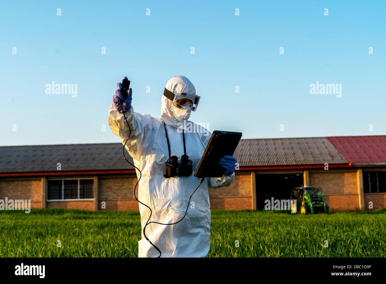 Female scientist researching in field and using measuring device Stock ...