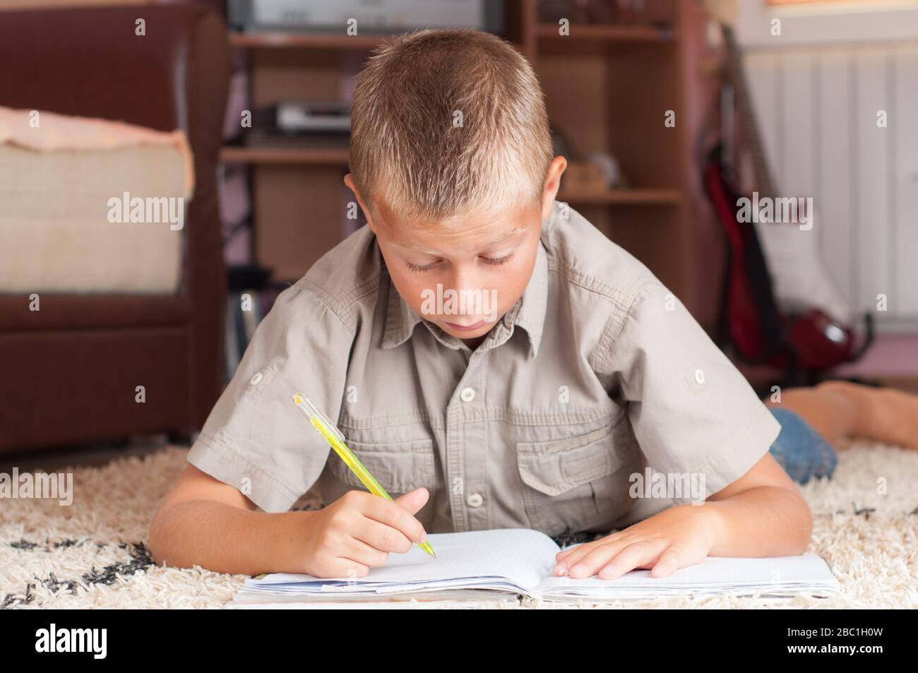 Young boy doing his homework at home - education Stock Photo - Alamy