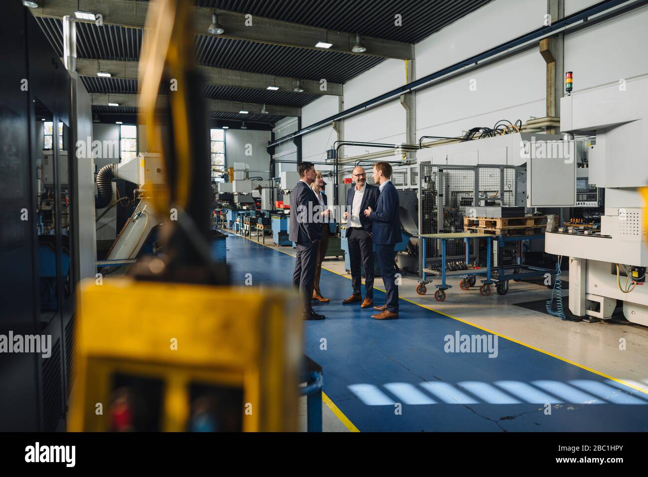 Business team having a meeting in a factory Stock Photo - Alamy
