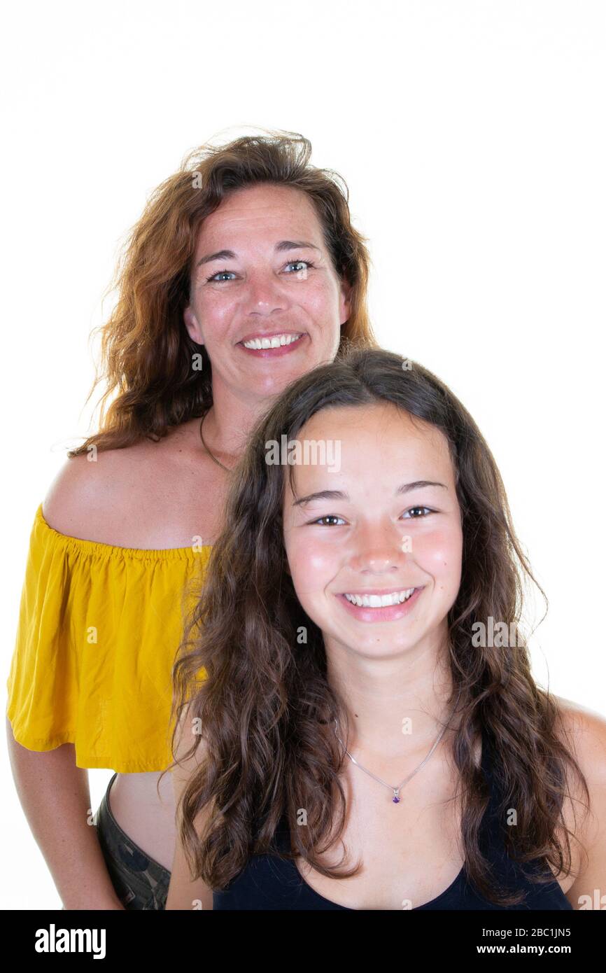 Attractive happy curly mother and smiling teenage daughter Stock Photo ...