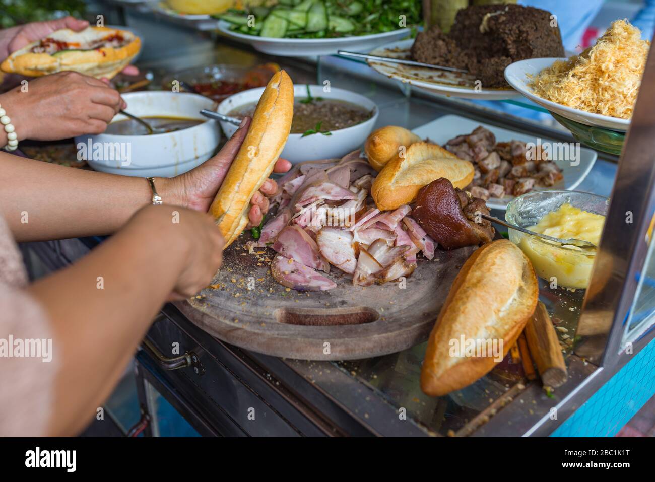 People making Banh Mi, Vietnamese famous local pork sandwich Stock ...