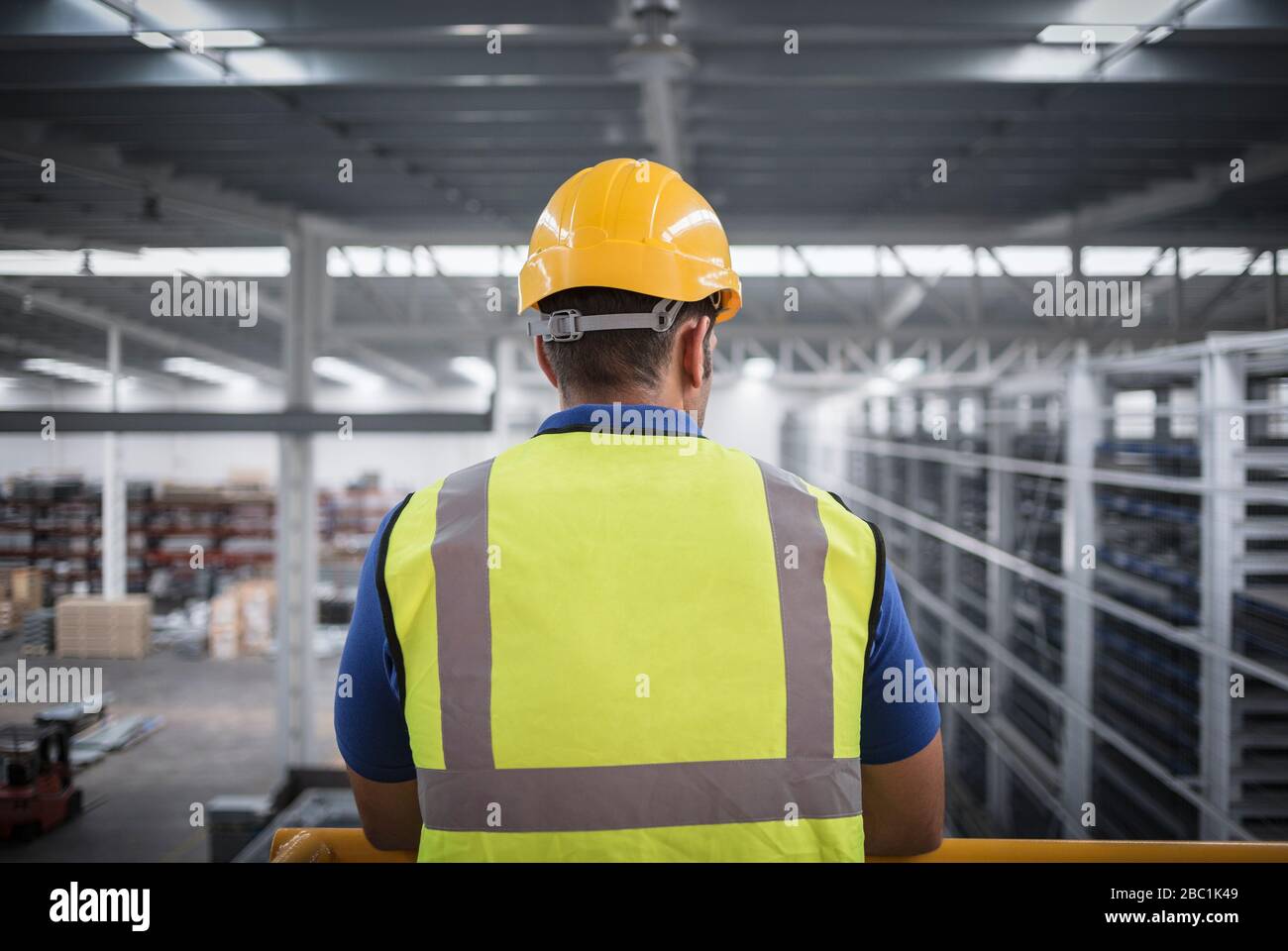 Male supervisor watching factory from platform Stock Photo - Alamy