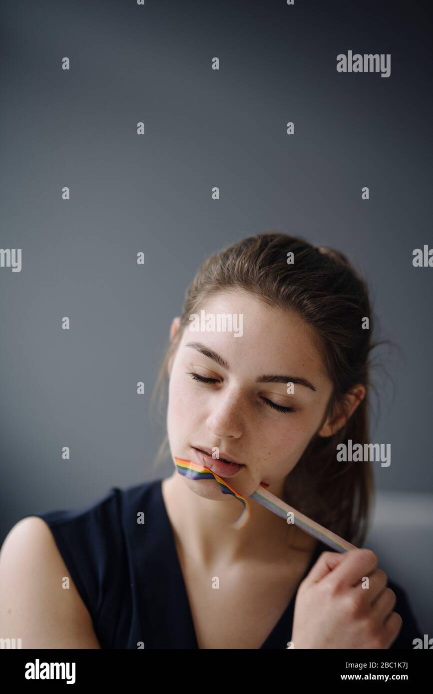 Portrait of young woman pulling off sticky tape from her mouth Stock ...