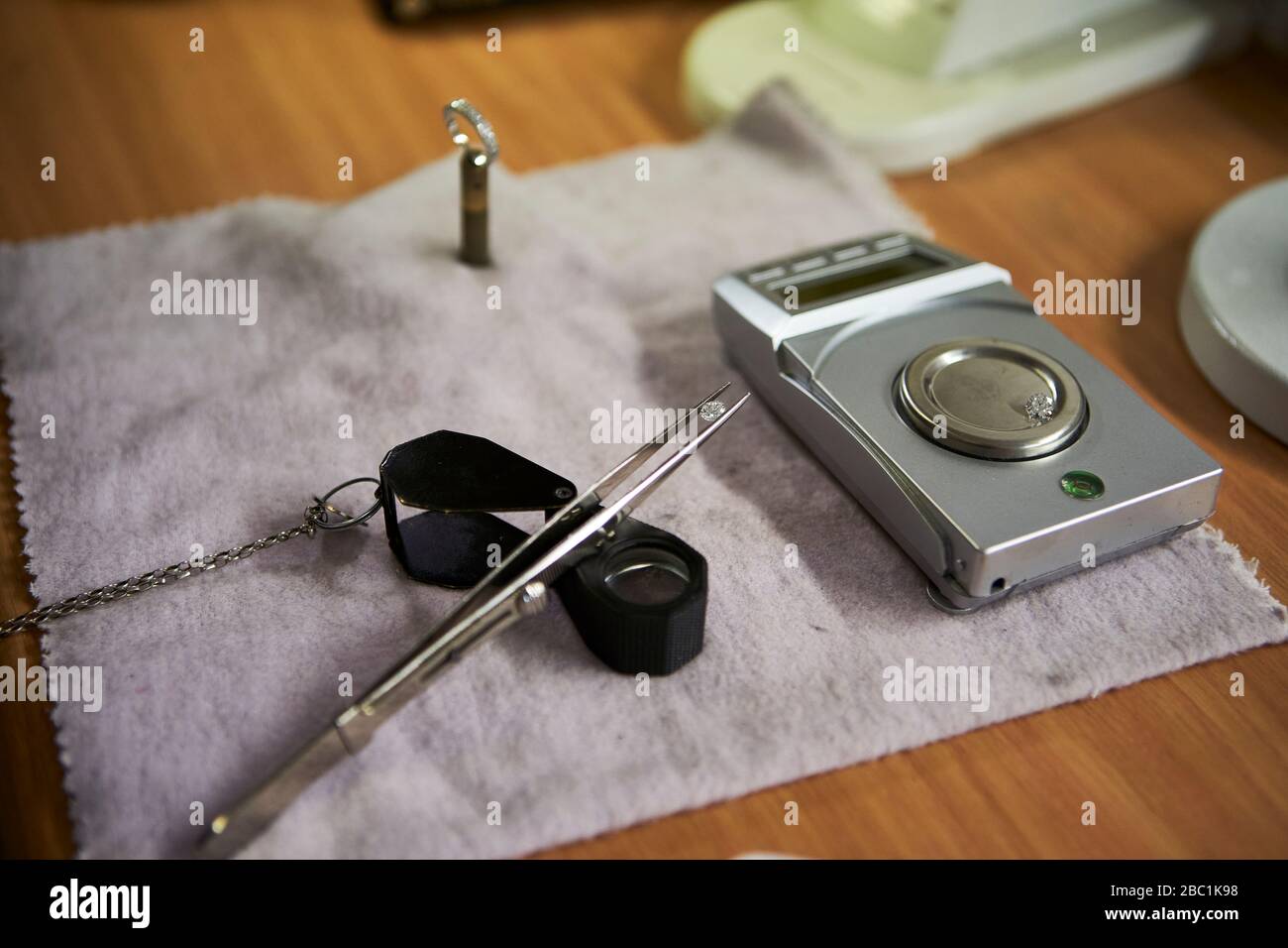 Diamond ring, amplifying glass and tweezers holding a diamond Stock ...