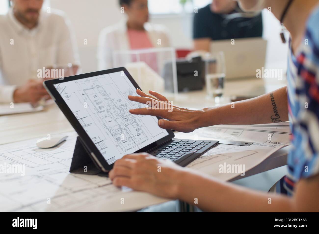 Female architect viewing digital blueprint on touch screen digital ...