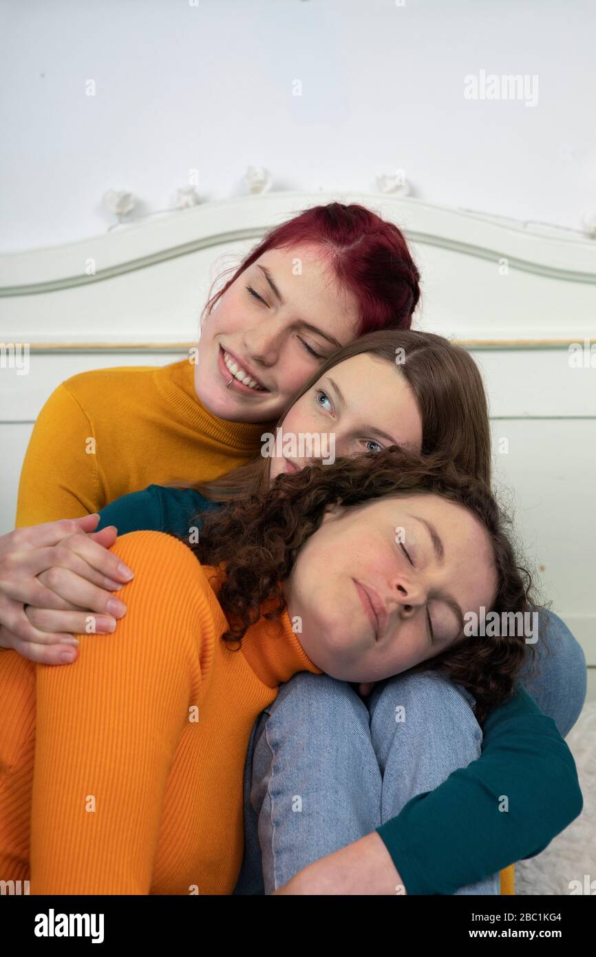 Portrait of three sisters cuddling together Stock Photo - Alamy