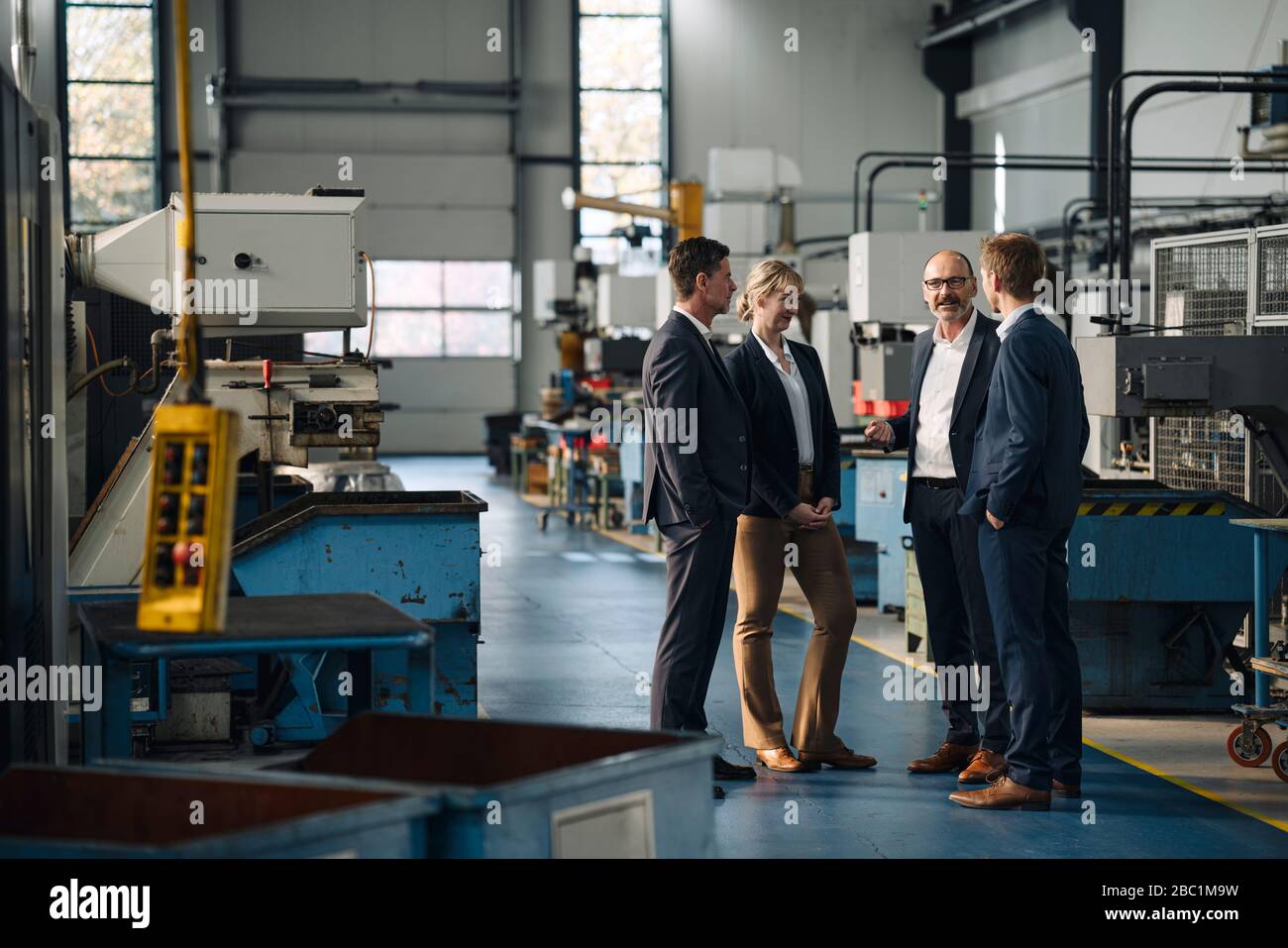 Business team having a meeting in a factory Stock Photo - Alamy