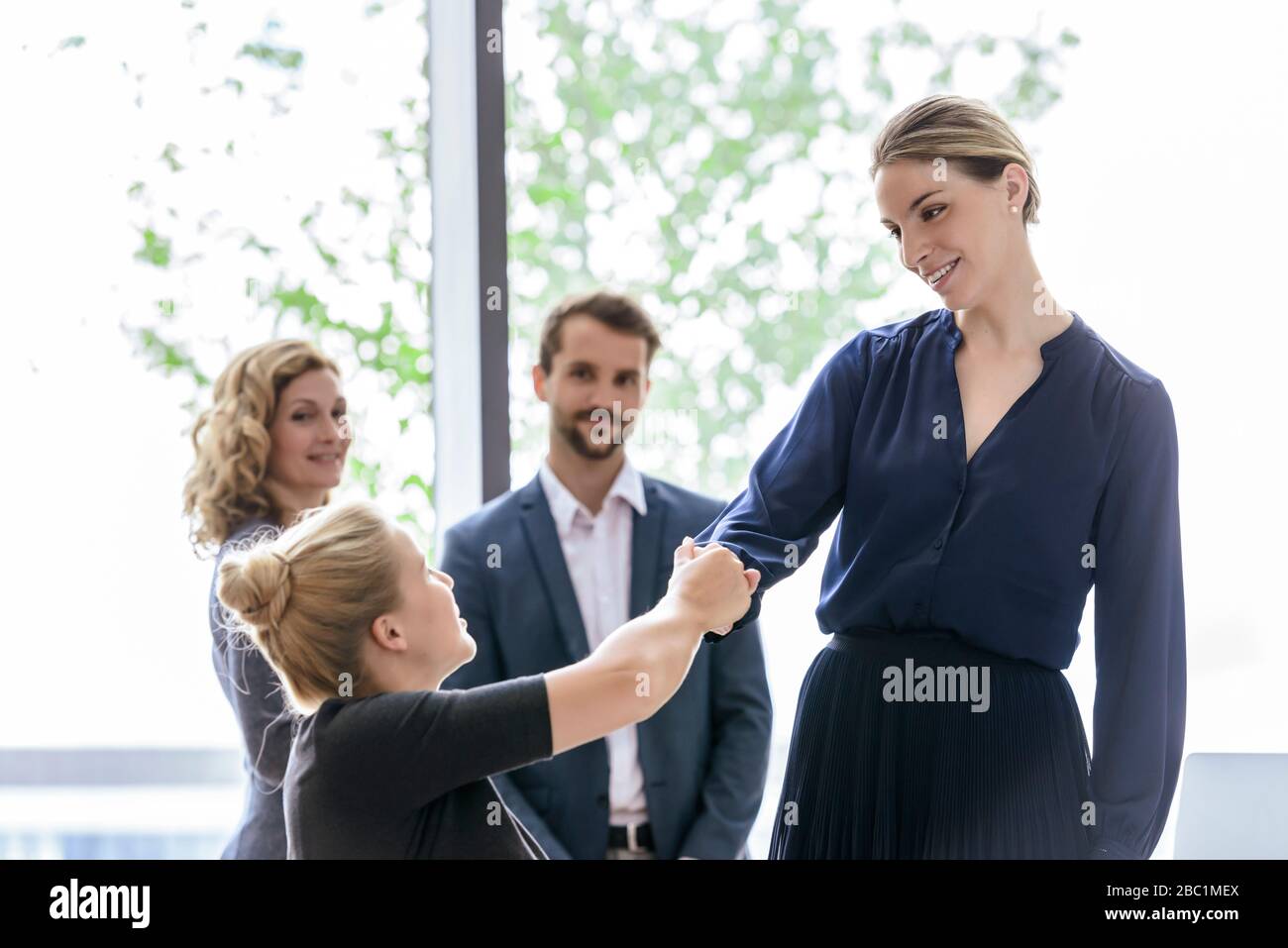 Greeting colleagues hi-res stock photography and images - Alamy