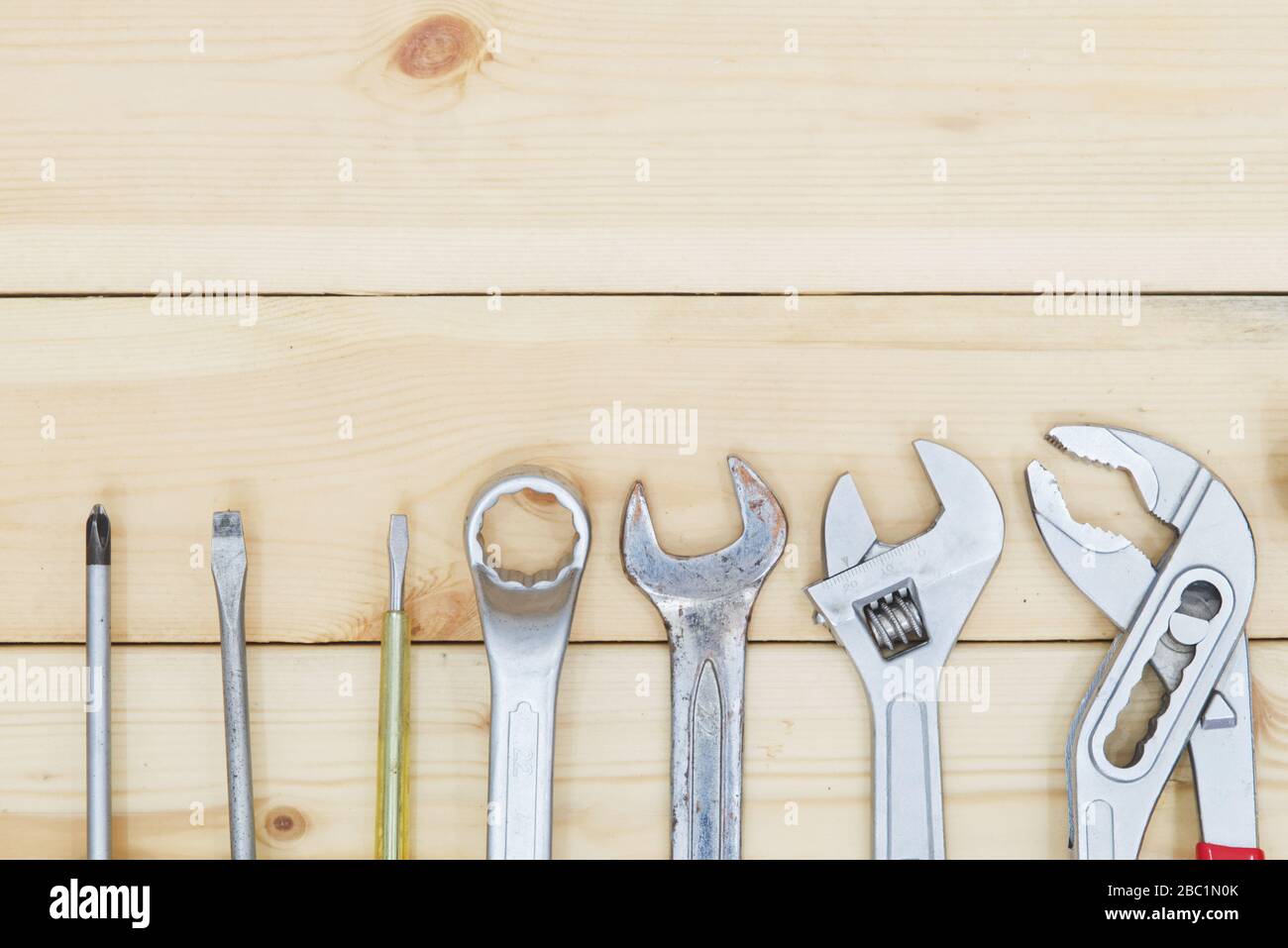 Tools set on wood table. screwdriver and wrench.Technical tooling ...