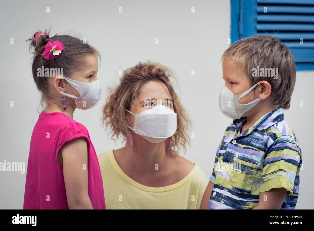 Family wearing facial disposable mask to avoid viral infection ...