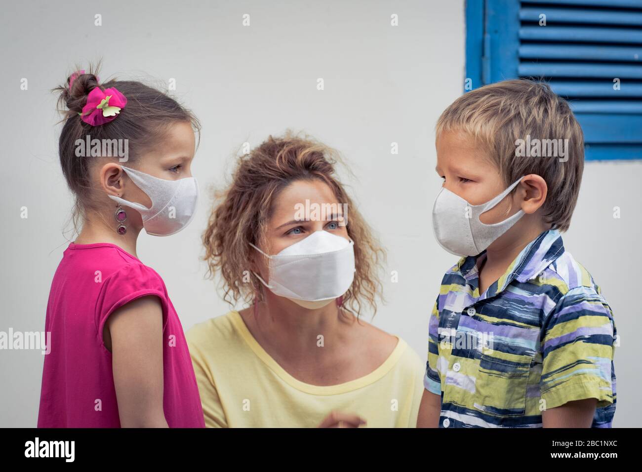 Family wearing facial disposable mask to avoid viral infection ...