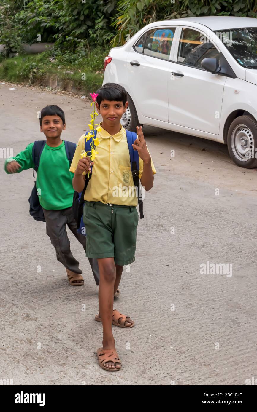 Portrait of poor children in school uniforms gathered together to show ...