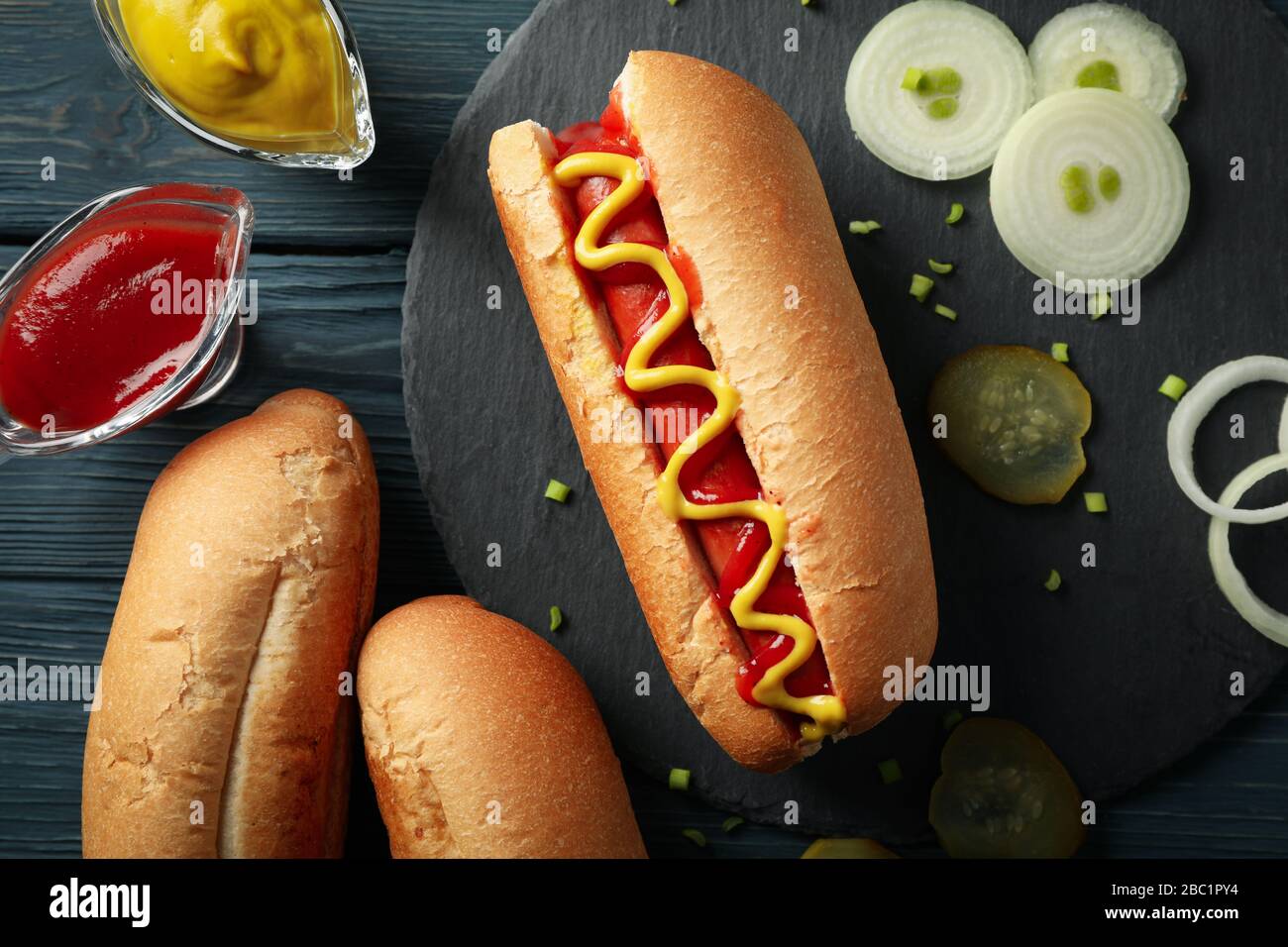 Tasty hot dog and ingredients on wooden background Stock Photo - Alamy
