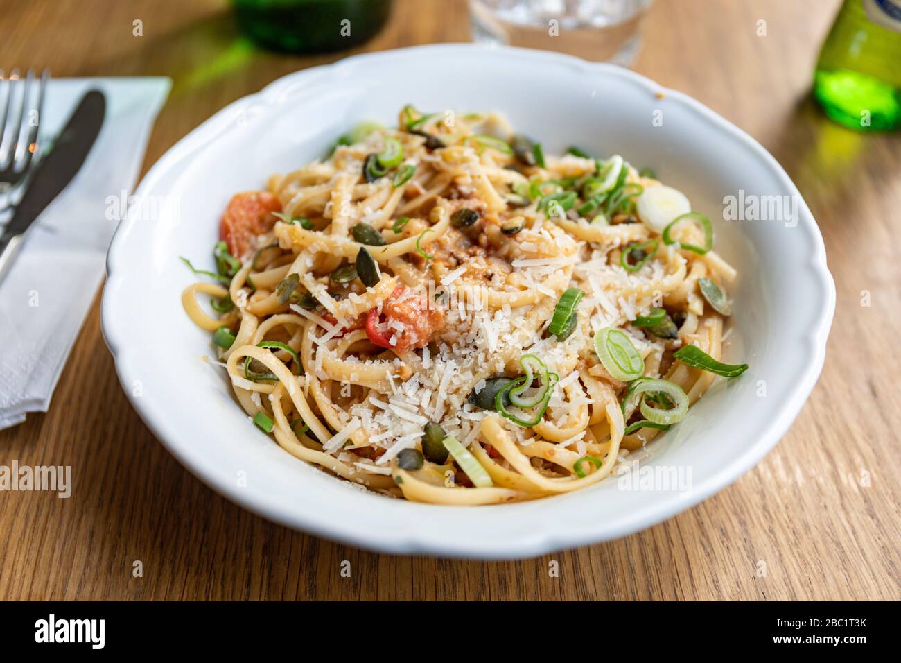 Bowl of pasta with spring onions and grated parmesan cheese Stock Photo ...