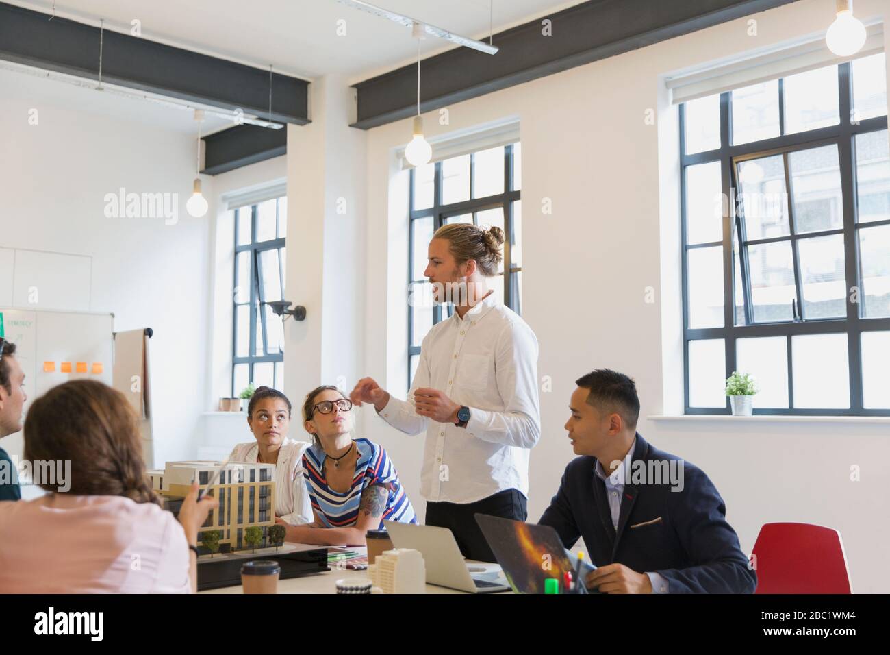 Male architect leading conference room meeting Stock Photo - Alamy