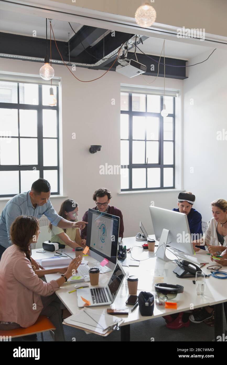 Computer programmers programming virtual reality simulator glasses in ...