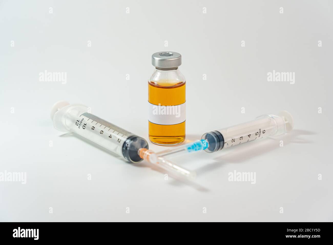 Orange vaccine bottle with blank label and syringe injection on white ...