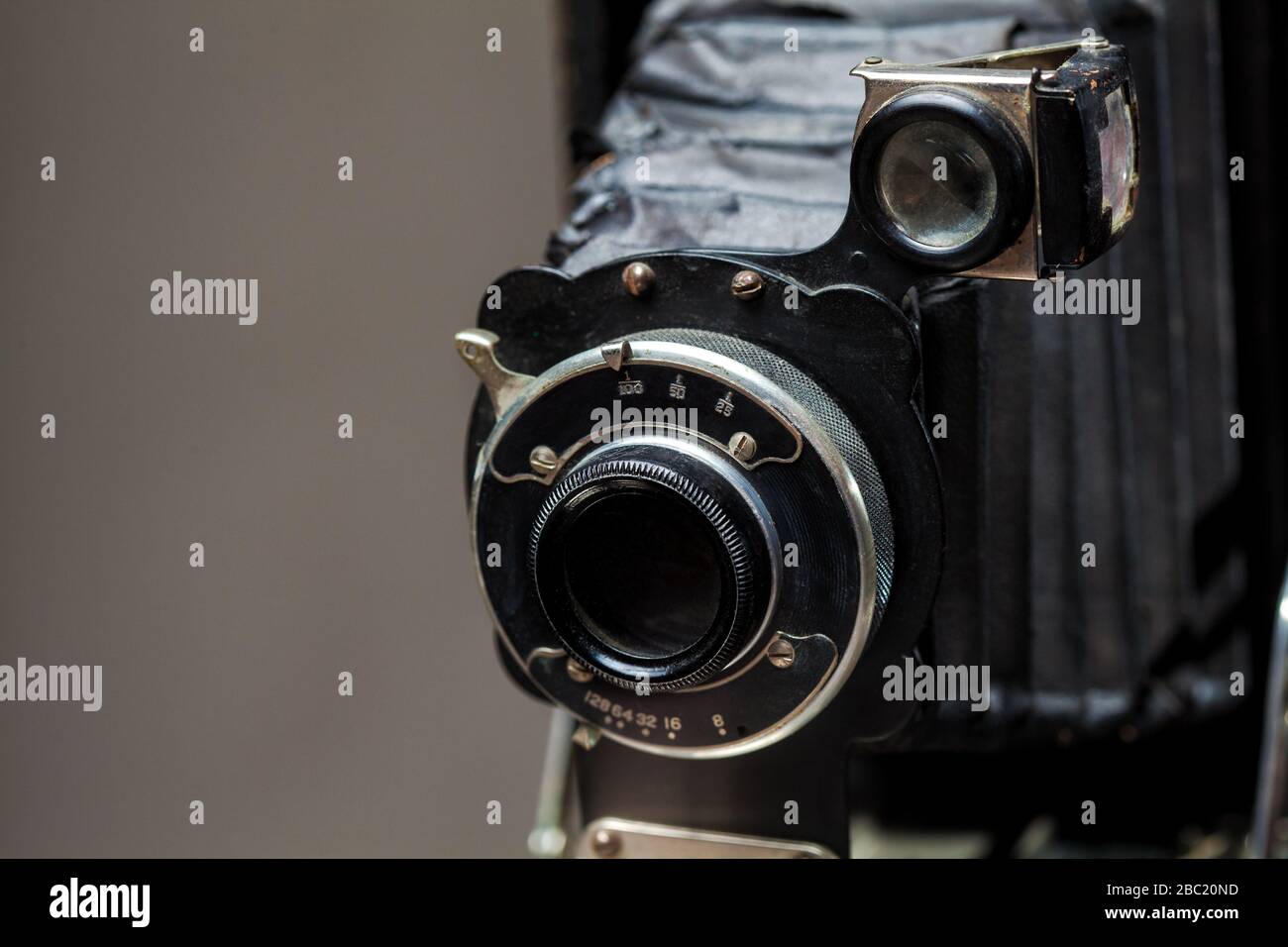 Old vintage classic camera on gray background Stock Photo - Alamy