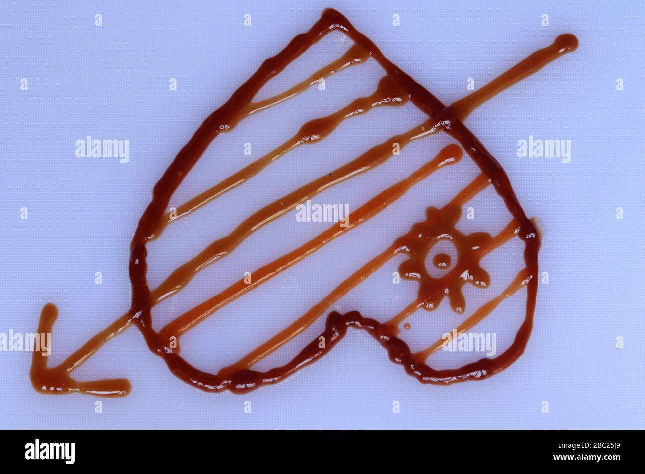 Ketchup in a shape of heart on white background Stock Photo - Alamy