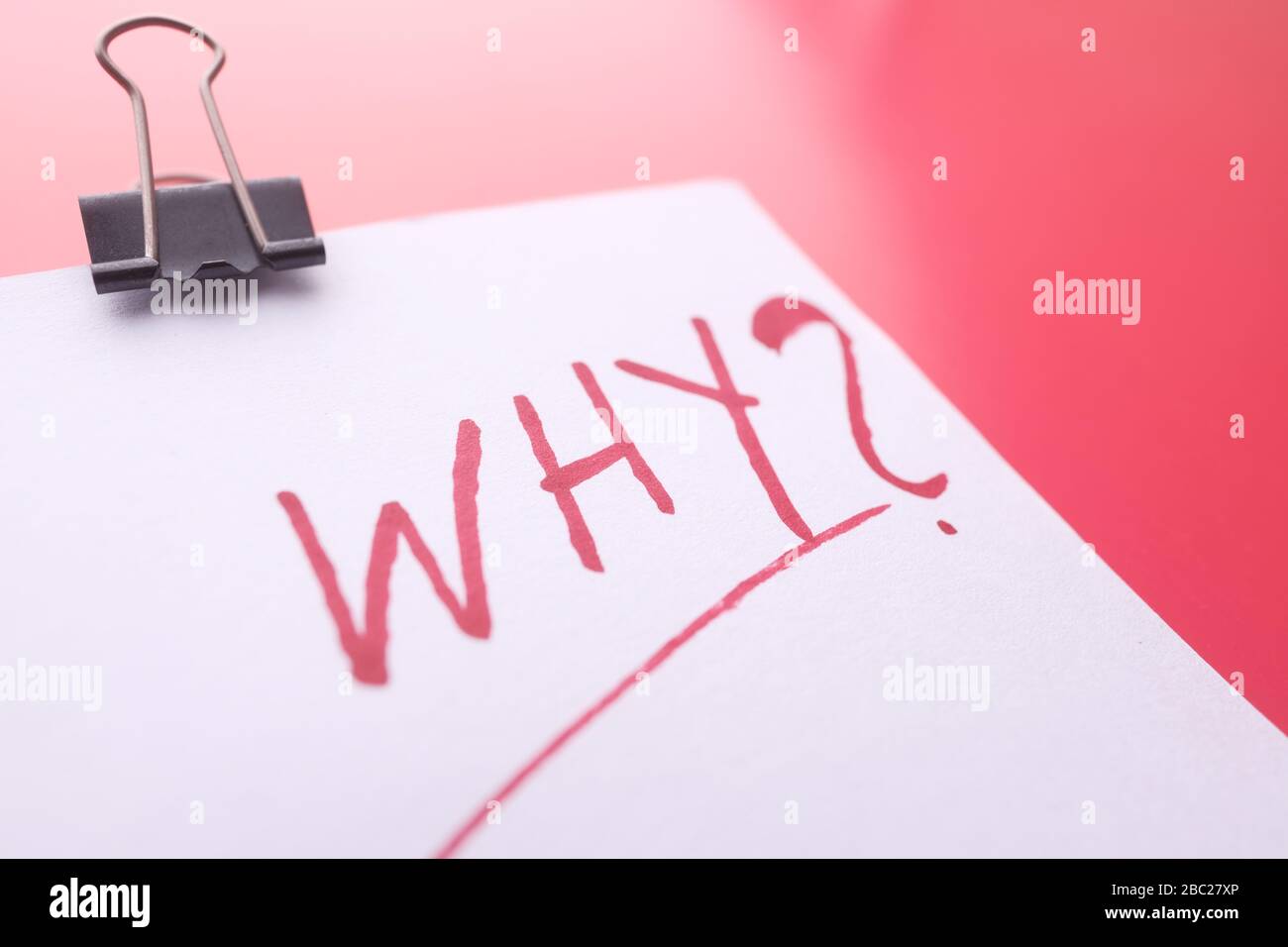 The text WHY on white paper on red background Stock Photo - Alamy