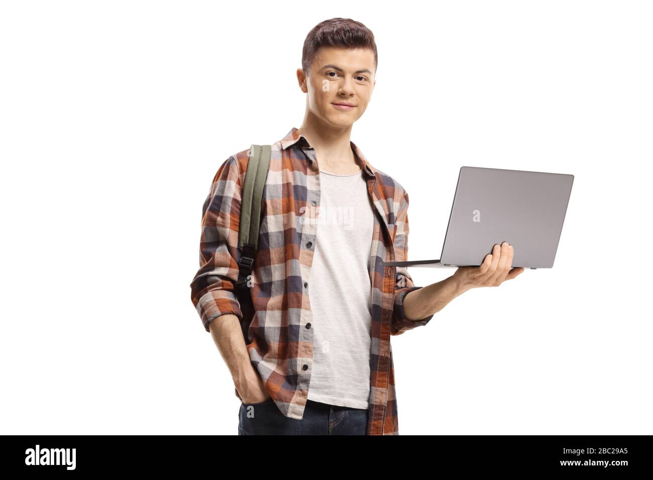 Student holding a laptop computer and looking at the camera isolated on ...