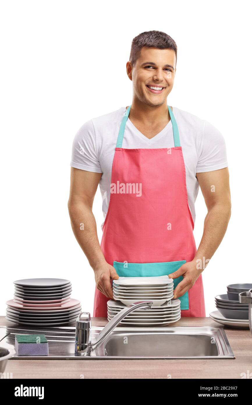 Young handsome guy wearing an apron and washing dishes isolated on ...