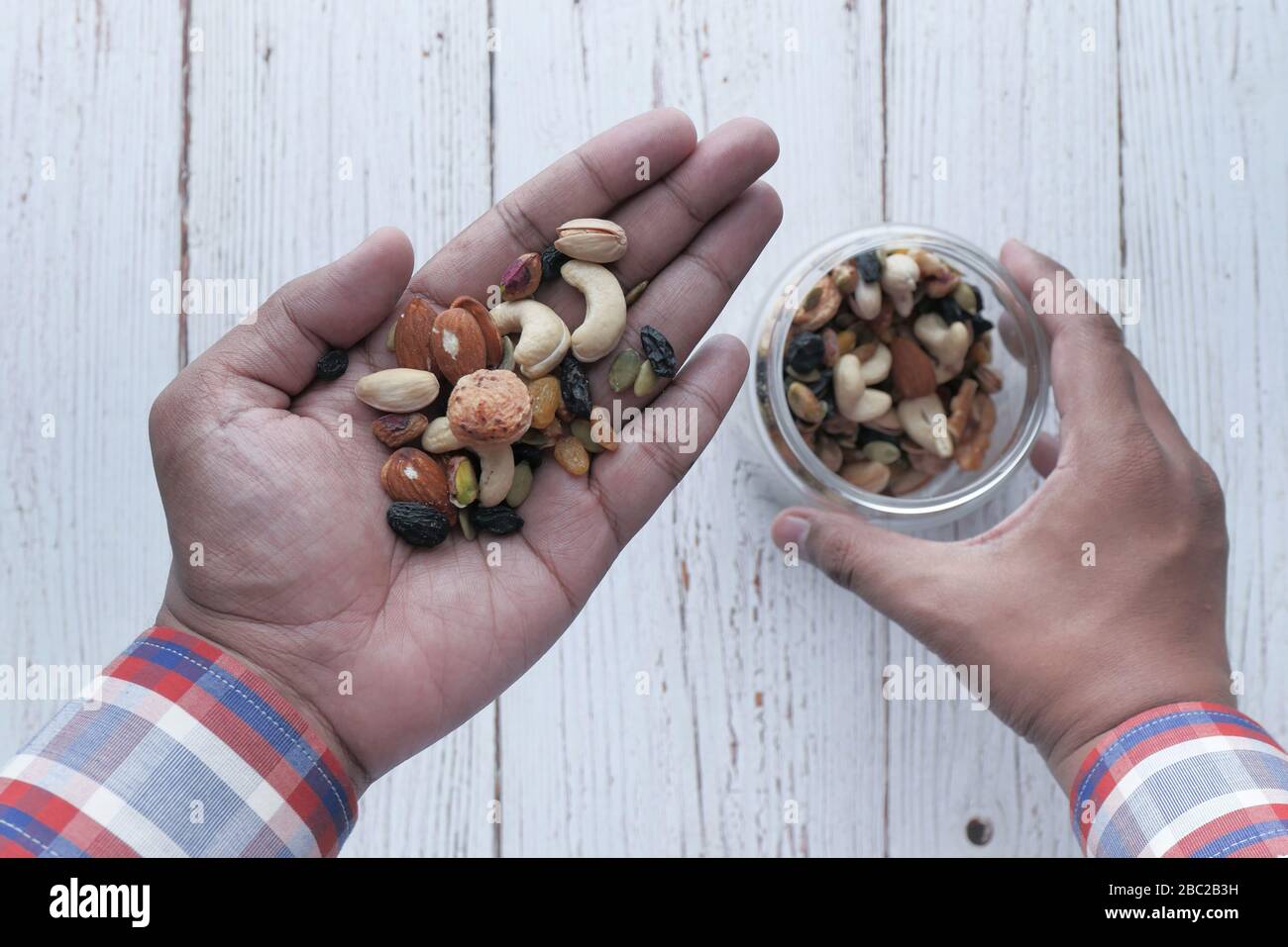 top view of mixed nut on man hand Stock Photo - Alamy