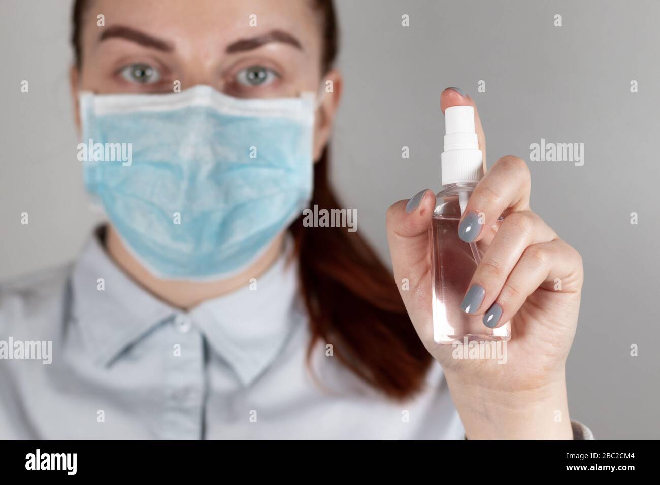 Spray sanitizer in female doctor hands on black background Stock Photo ...